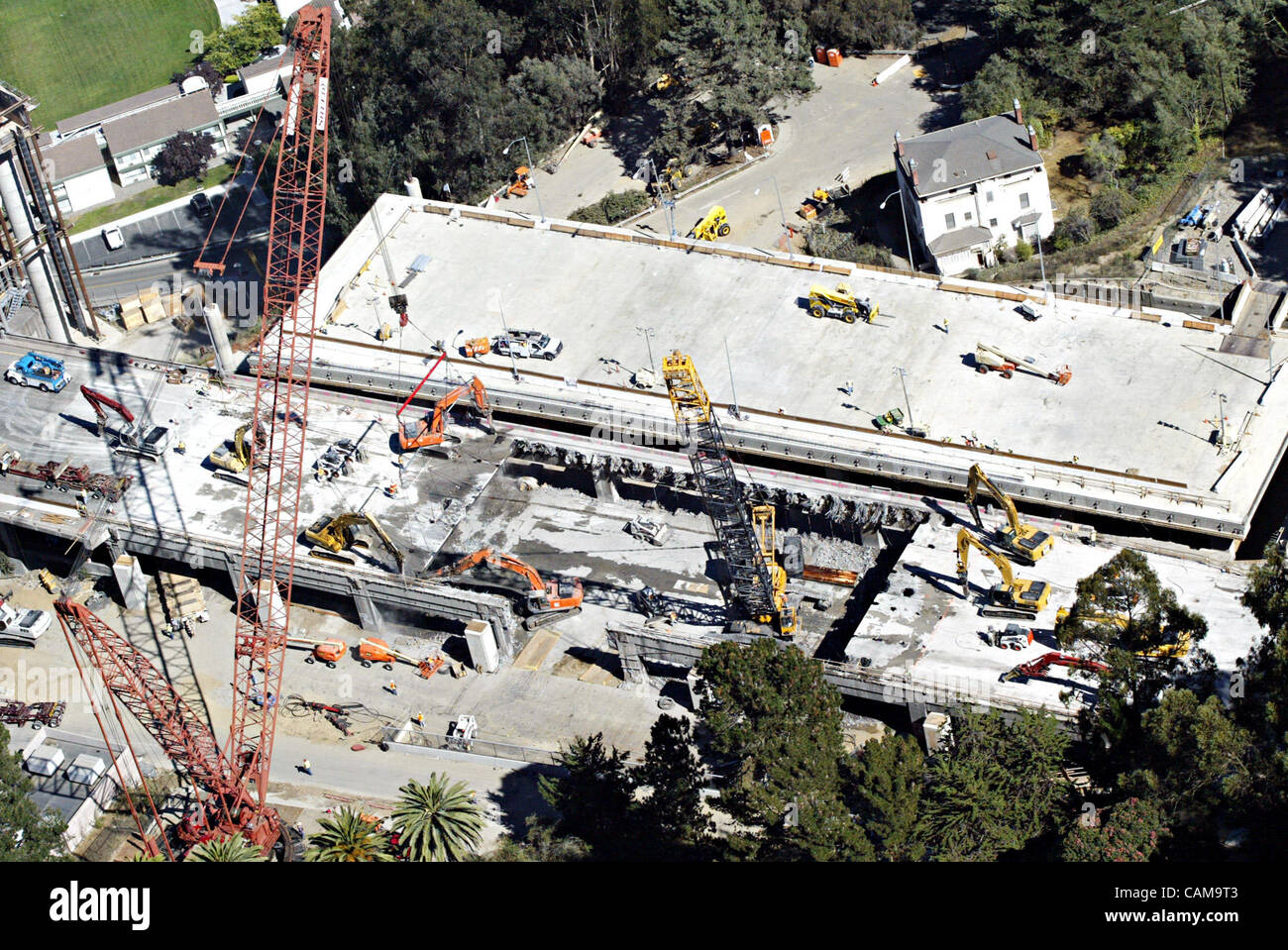Workers from C.C. Meyers demolish a 350-foot section of the eastern ...