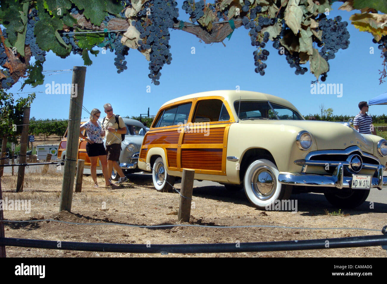 Karen Russcher and Mike Pinkney check out a 1949 Ford Custom station ...