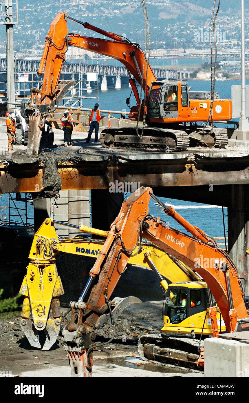 Construction workers from CC Myers Inc. demolish a section of the Bay ...