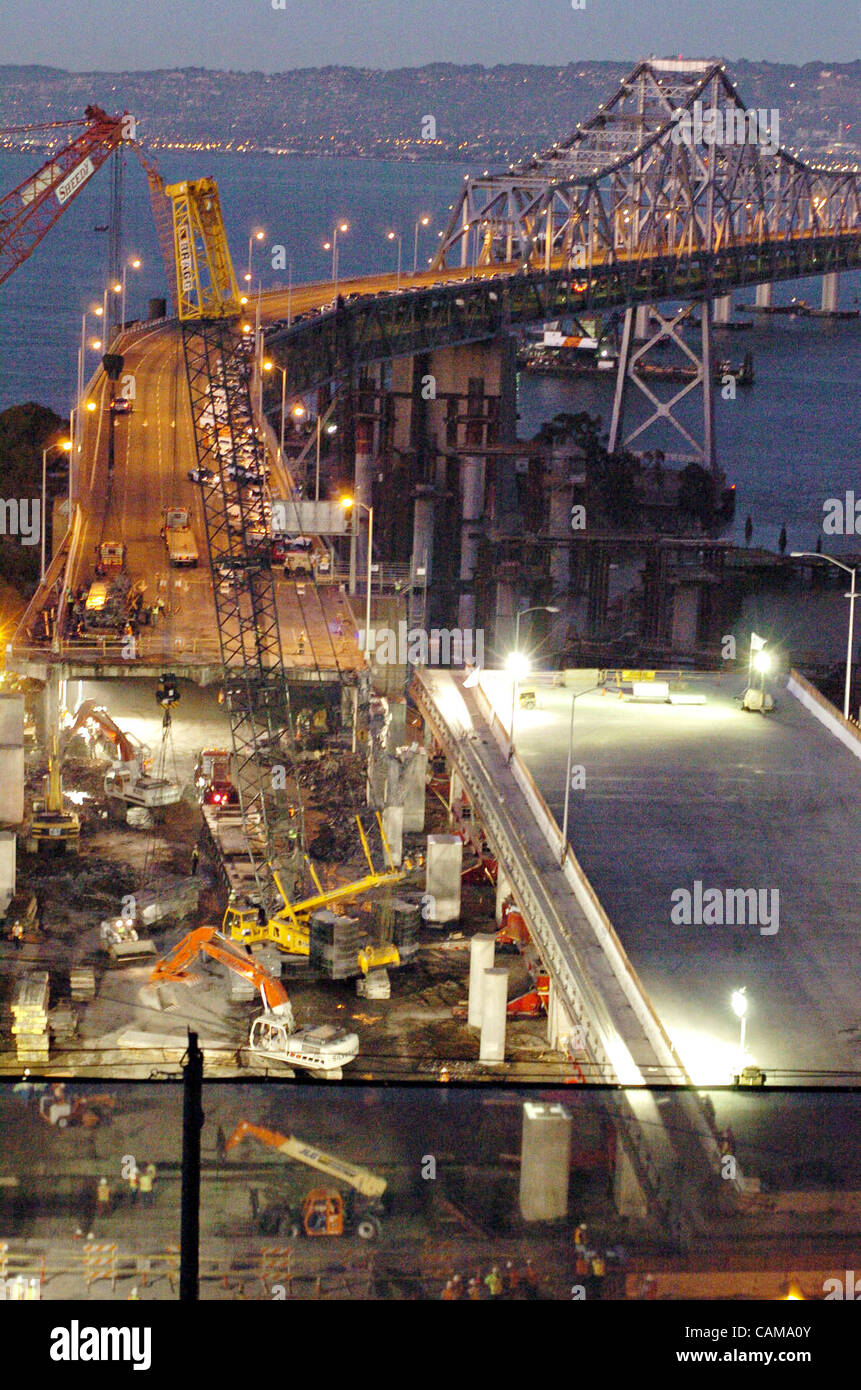 Construction workers from CC Myers Inc. finish clearing the remnants of ...