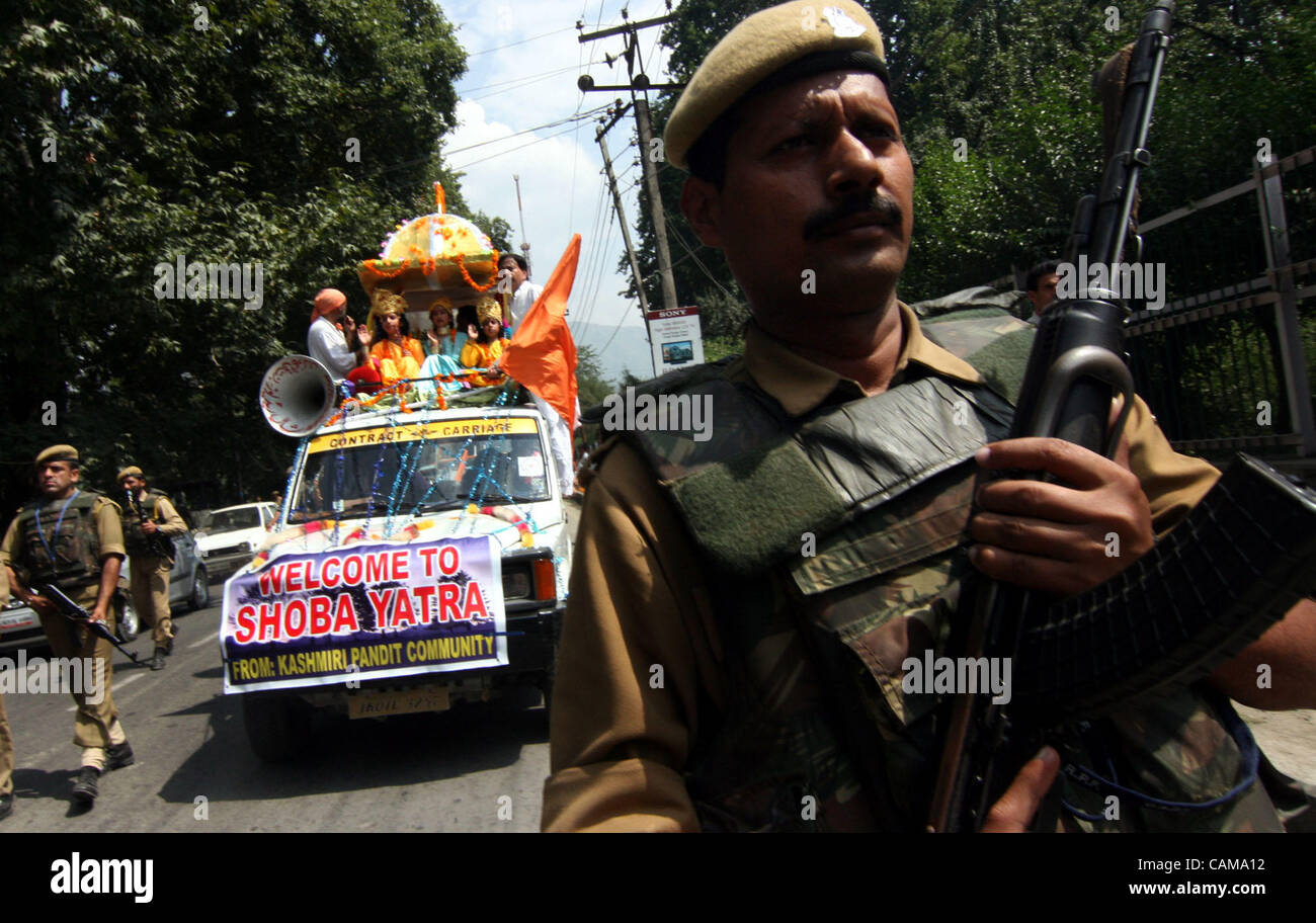 Indian paramilitary soldiers keep vigil as they walk along a Shoba ...