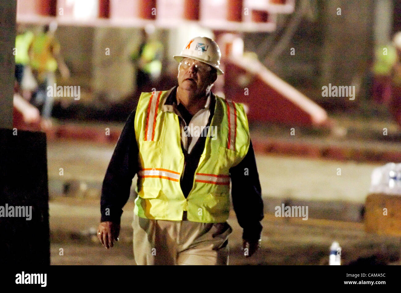 C.C Myers, owner of C.C. Myers Construction, looks over the work of his ...