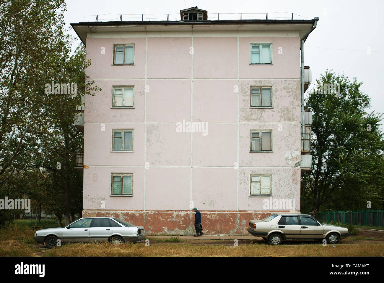 A villager walks past a residential building in Stepnogorsk Kazakhstan ...