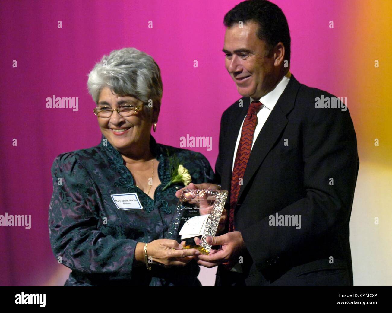 Mary Helen Rocha, of The Perinatal Council, left, is given an award by ...