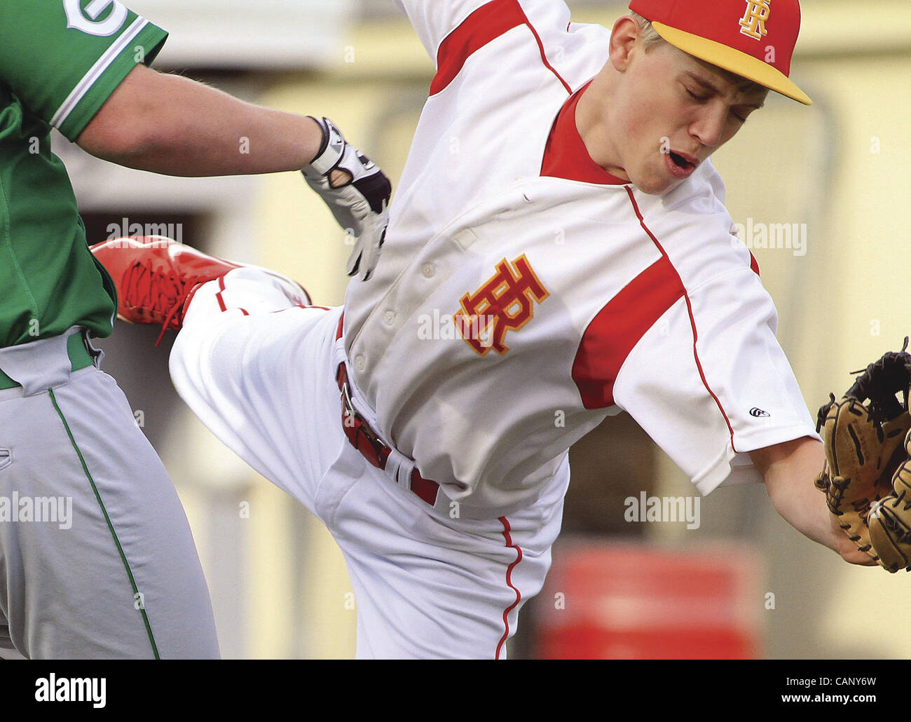 March 29, 2012 - Rock Island, Iowa, U.S. - Rock Island pitcher Chase Wiggins collides with ...