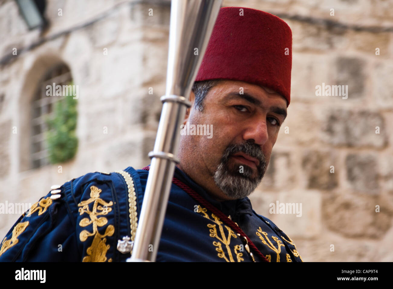 A scout leads the procession of Archbishop Fouad Twal, Latin Patriarch ...