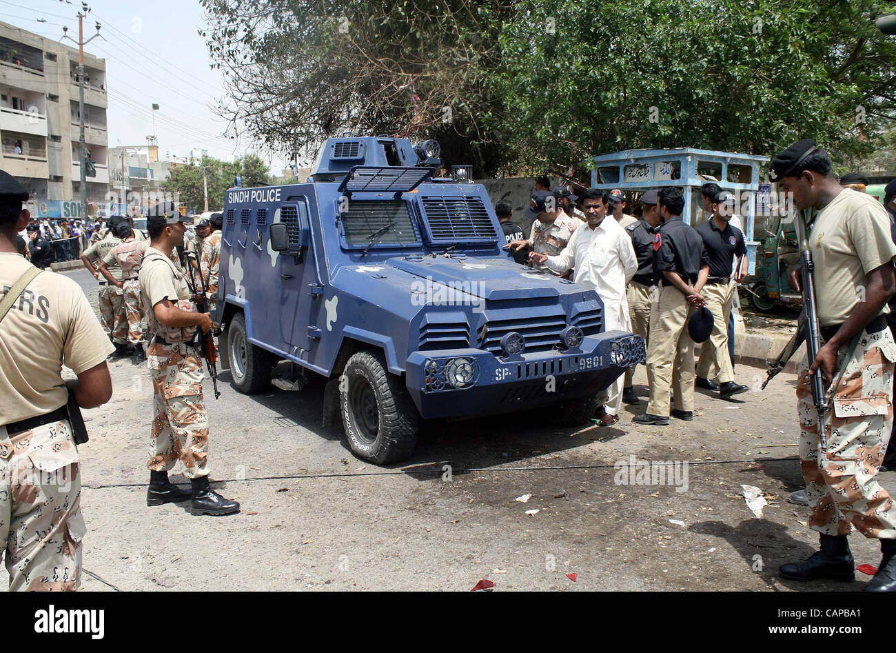 Security official inspect the damaged police armored personnel carrier ...