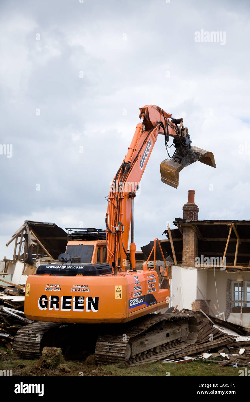 A demolition excavator demolishes a building in the UK Stock Photo - Alamy