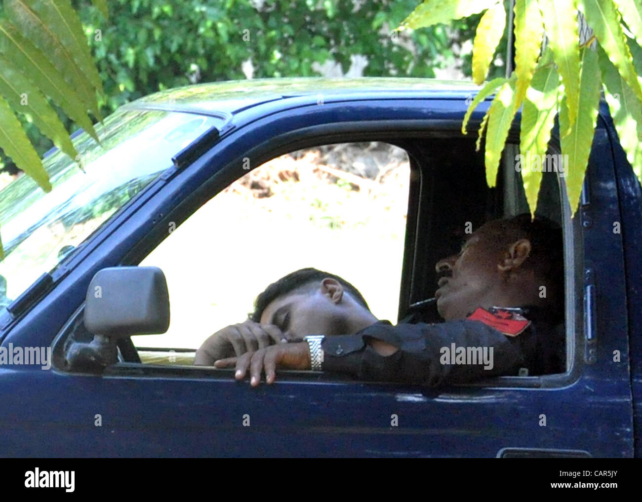 Policemen take nap in police mobile during duty at Royal Palm club in ...