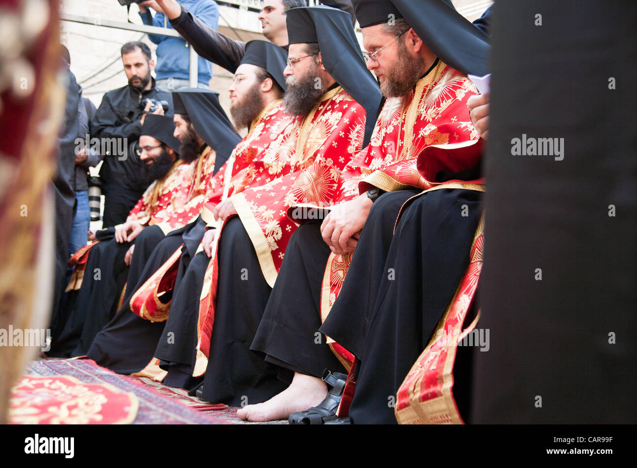 Barefooted priests await their turn in the traditional Washing of the ...