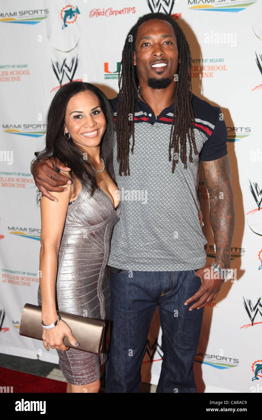 Retired NFL player Al Haris and guest pose for media on the red carpet ...