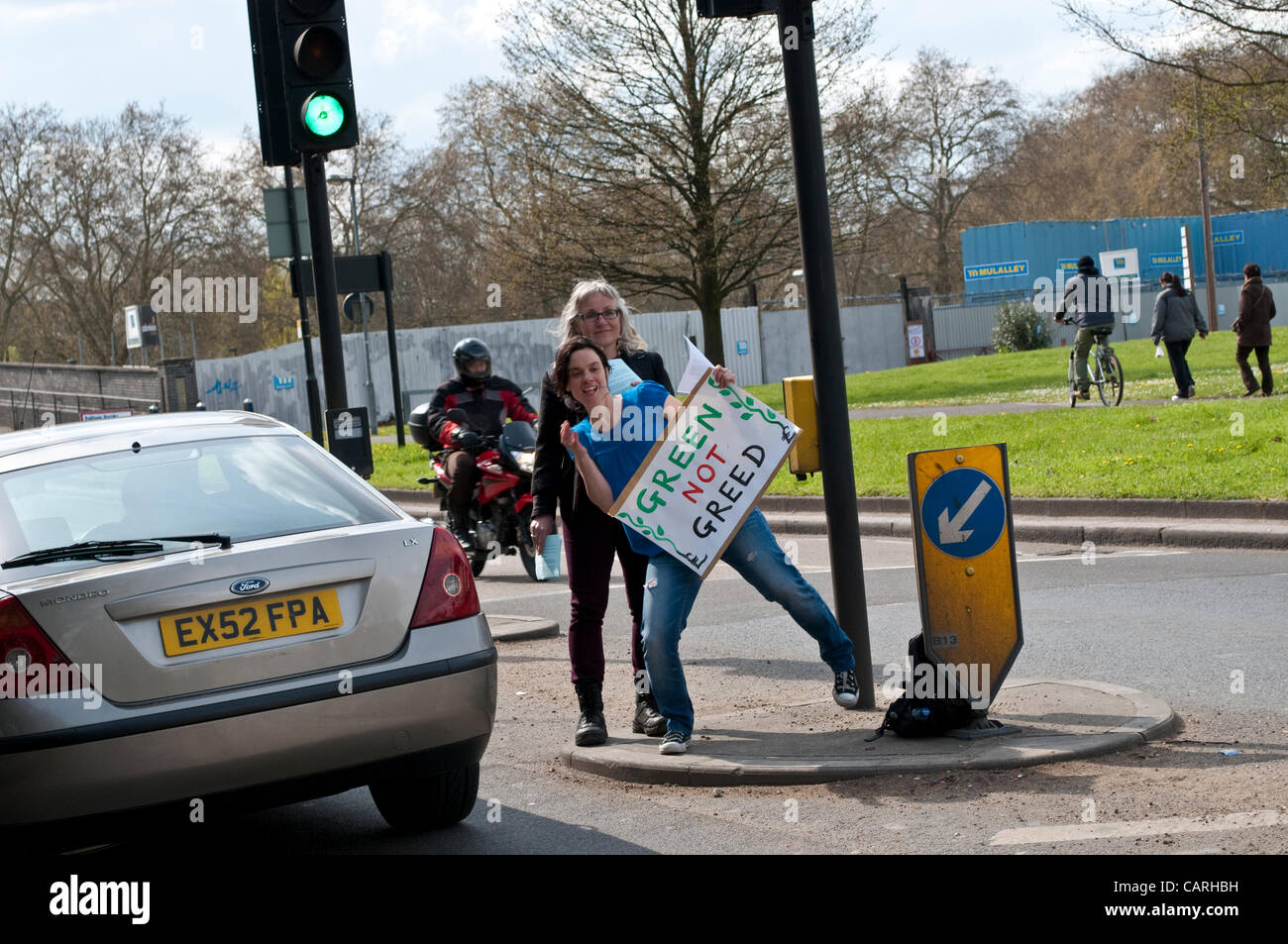Girl with 'Green not Greed' placard, Protesters against the ...