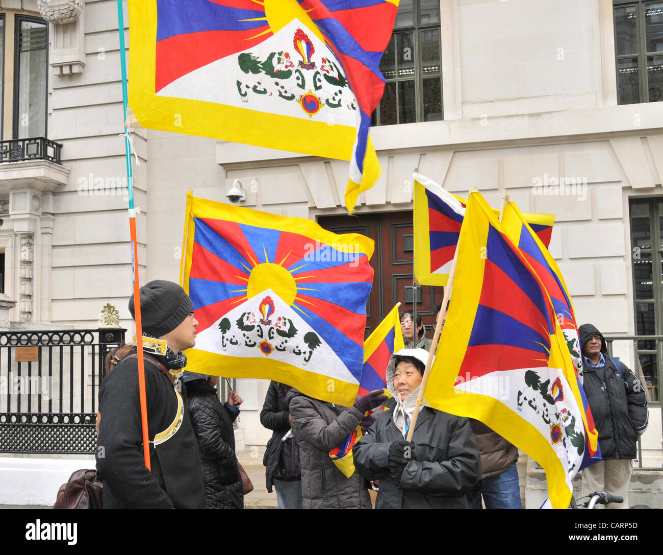 Tibetan activists holding the Tibetan flag as part of the protest in ...