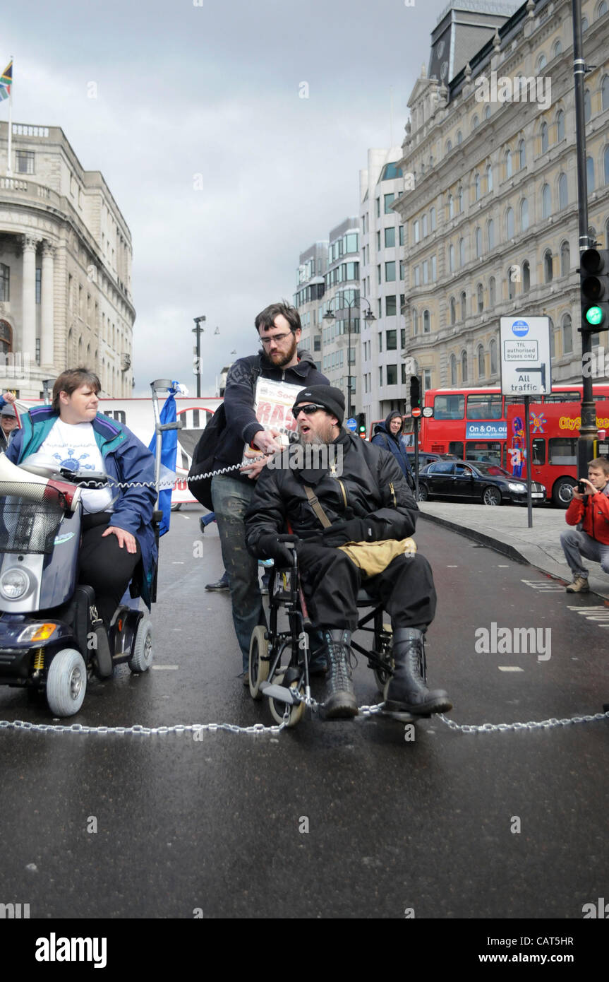 London, UK. 18/04/12. Disabled People Against Cuts (DPAC) blocking the ...