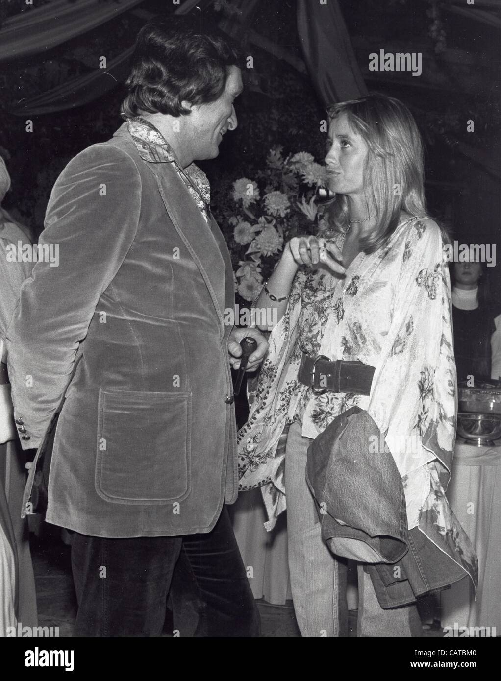 SUSAN GEORGE with Hugh Hefner to get in the buffet line at the ...