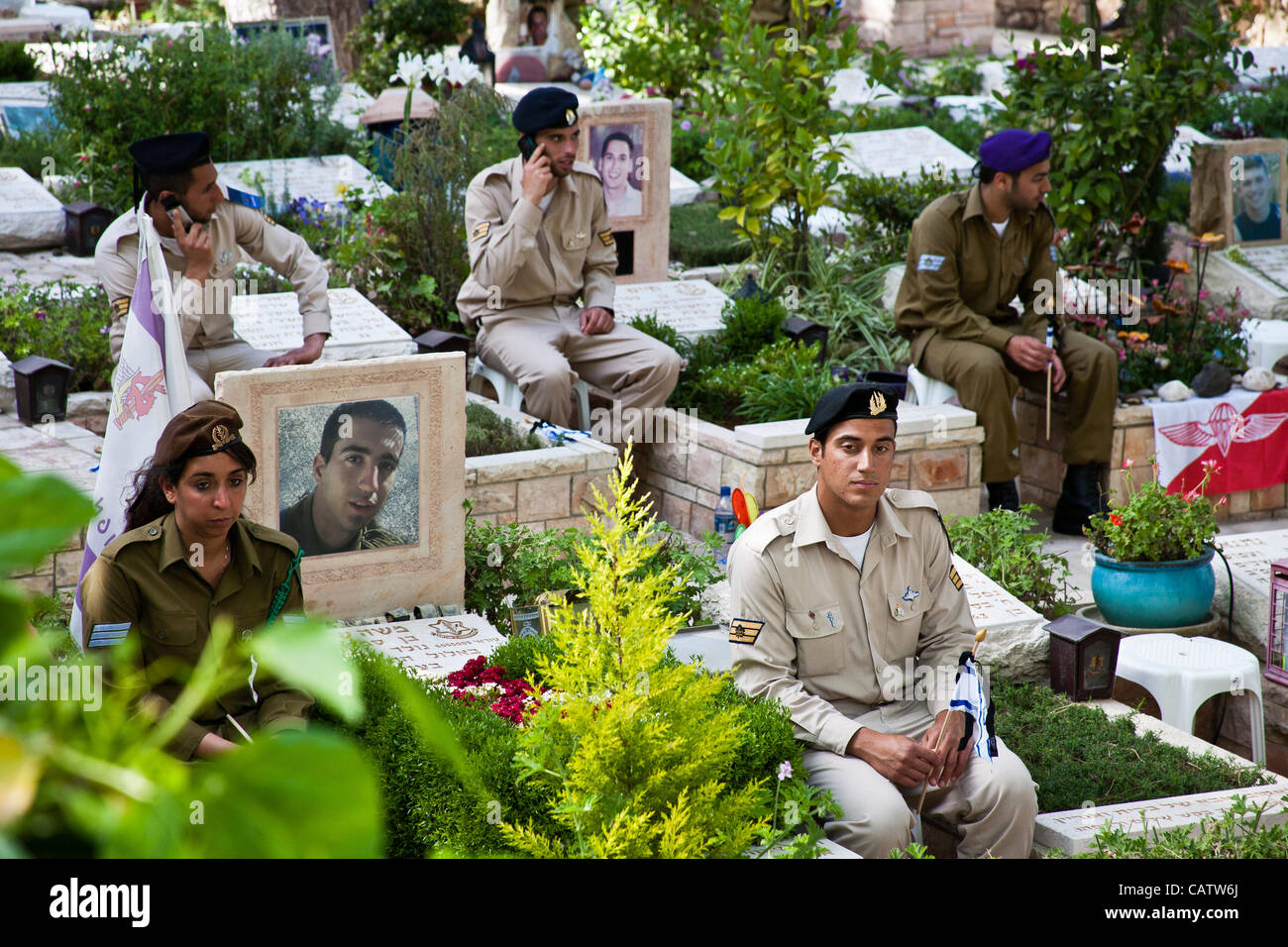IDF soldiers sit by the graves of fallen comrades awaiting their cue to ...