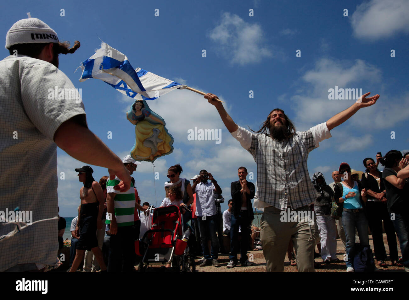 A religious Jew dance while waving Israeli flag at the seacoast ...