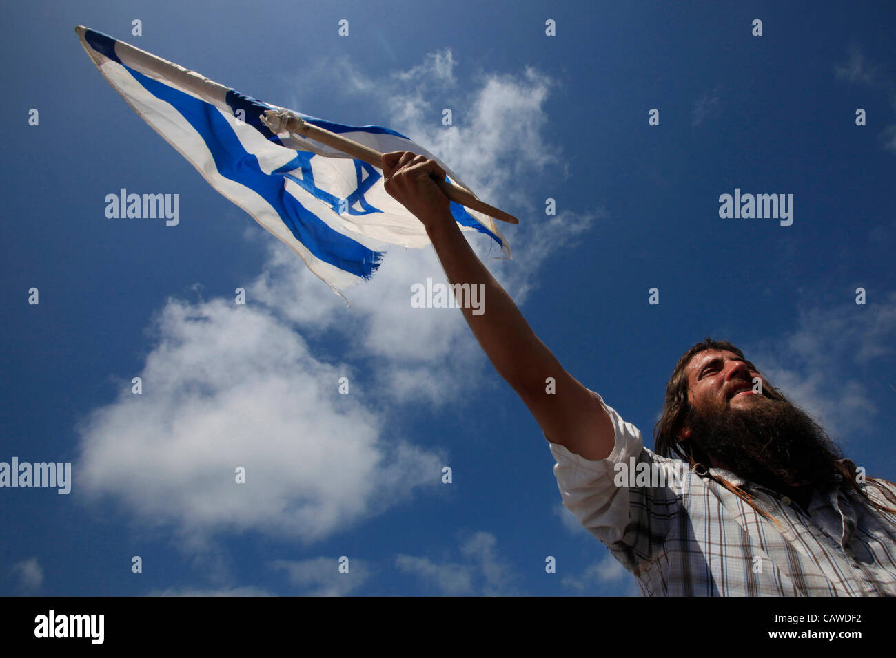 A religious Jewish man dance while waving Israeli flag at the promenade ...
