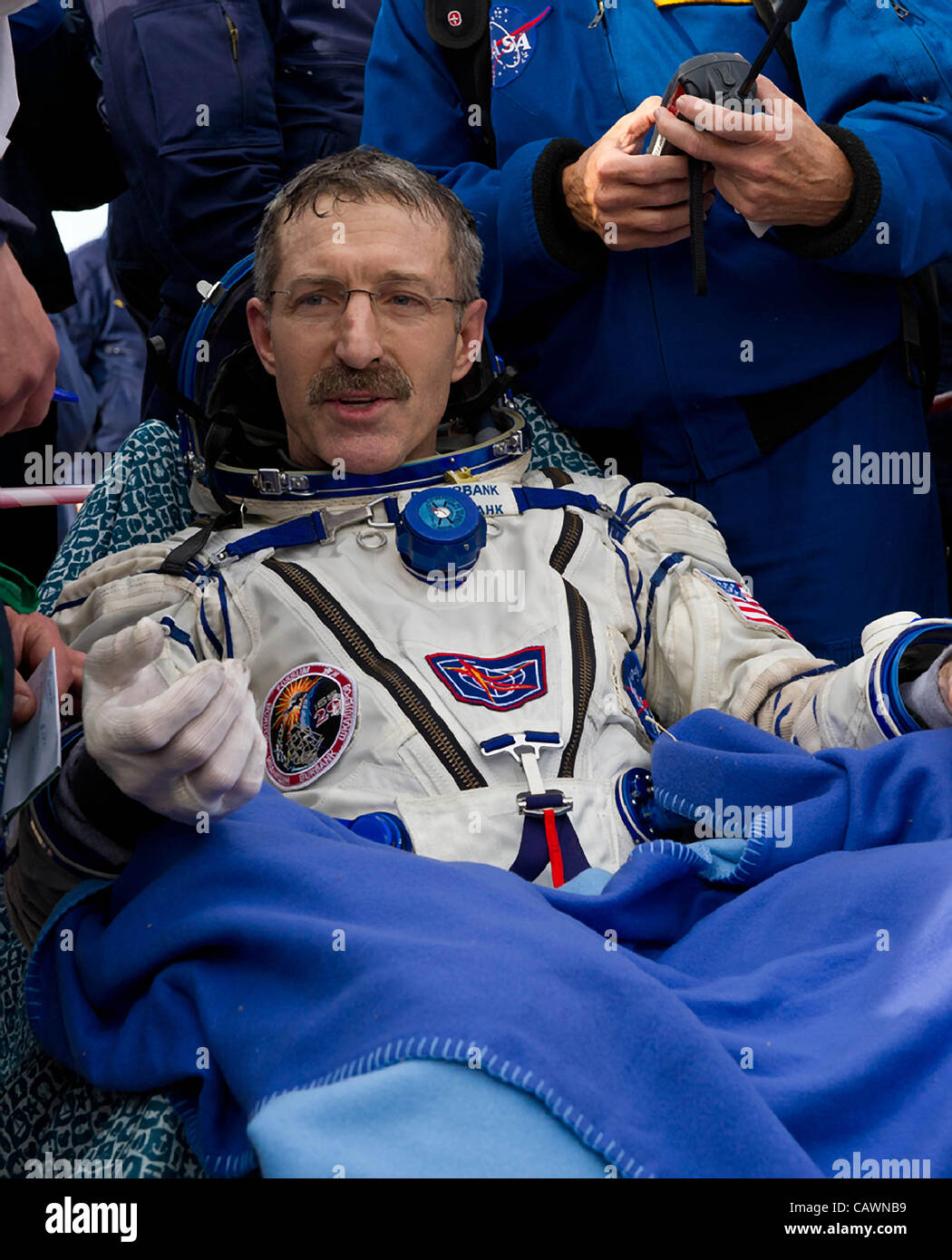 Expedition 30 Commander Dan Burbank rests following his landing in the ...