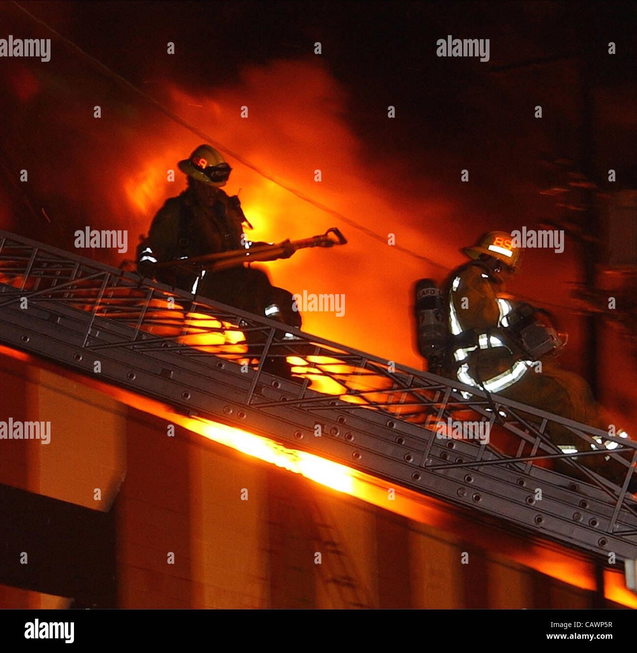 photo of LA city fire fighters as they slide down the ladder as fire ...