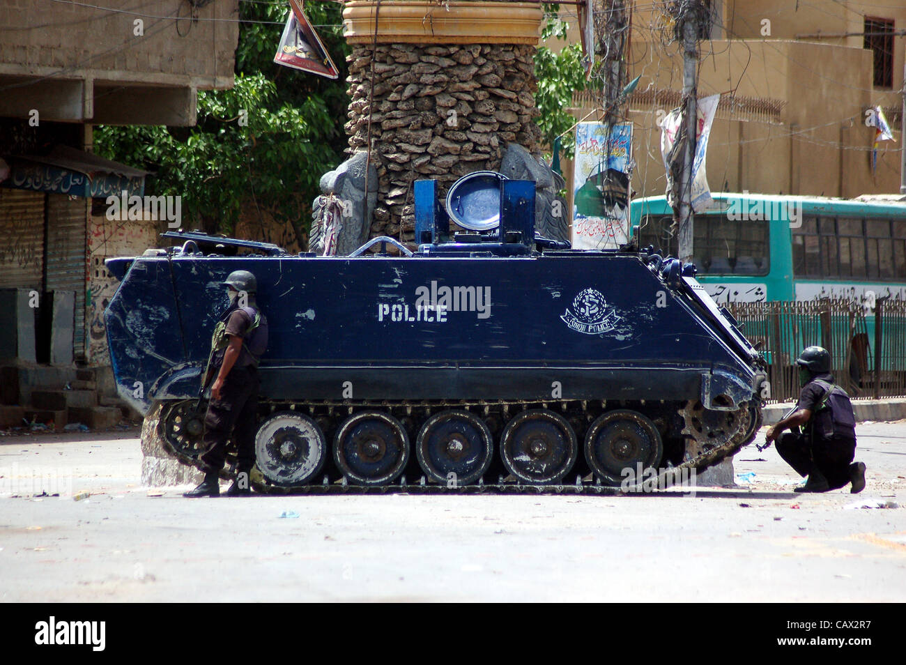 Policemen take positions with a police armored personnel carrier (APC ...