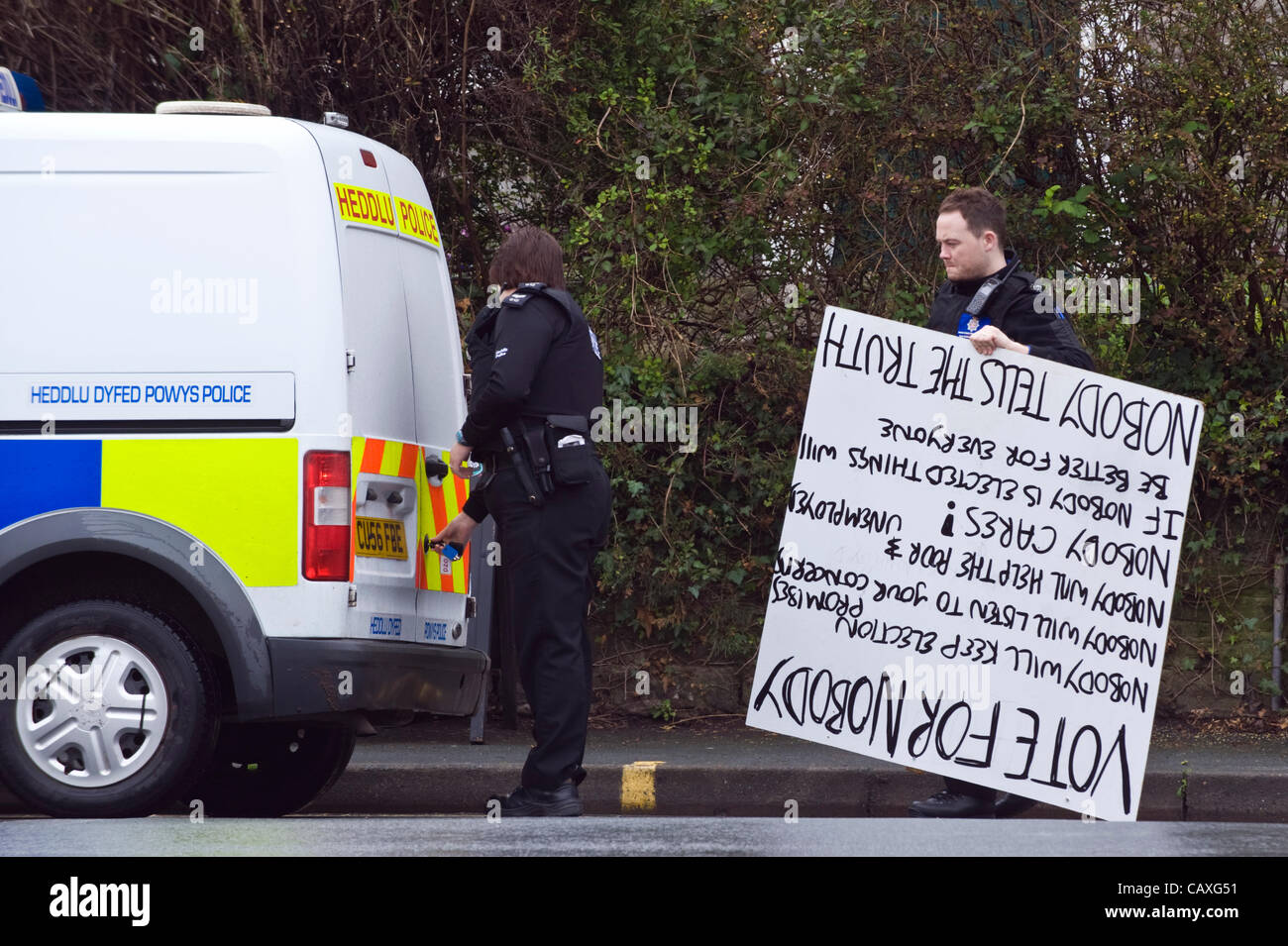 police uk. 3rd May 2012. Police CSO removing homemade sign asking ...