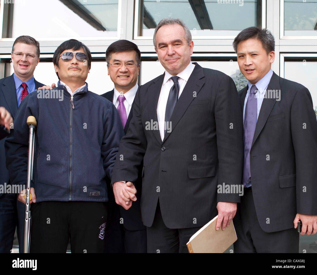 Blind dissident lawyer Chen Guangcheng, left, holds hands with US ...