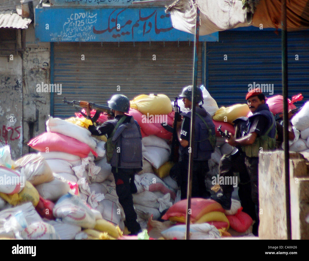 Policemen stand guard at a check-post during operation against ...
