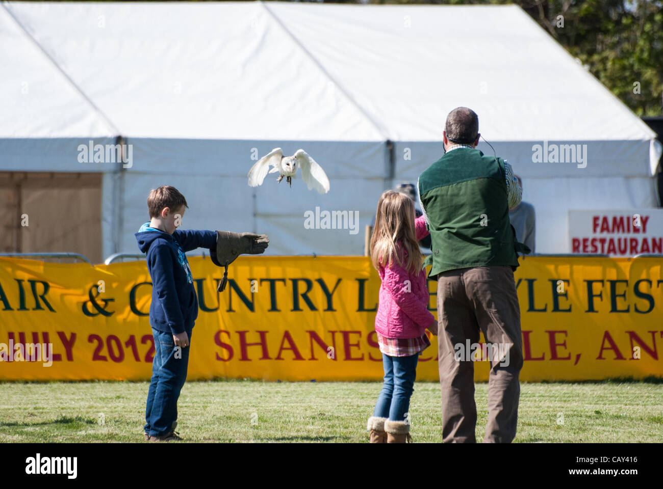 Young boy releasing a Barn Owl under the watchful gaze of John ...