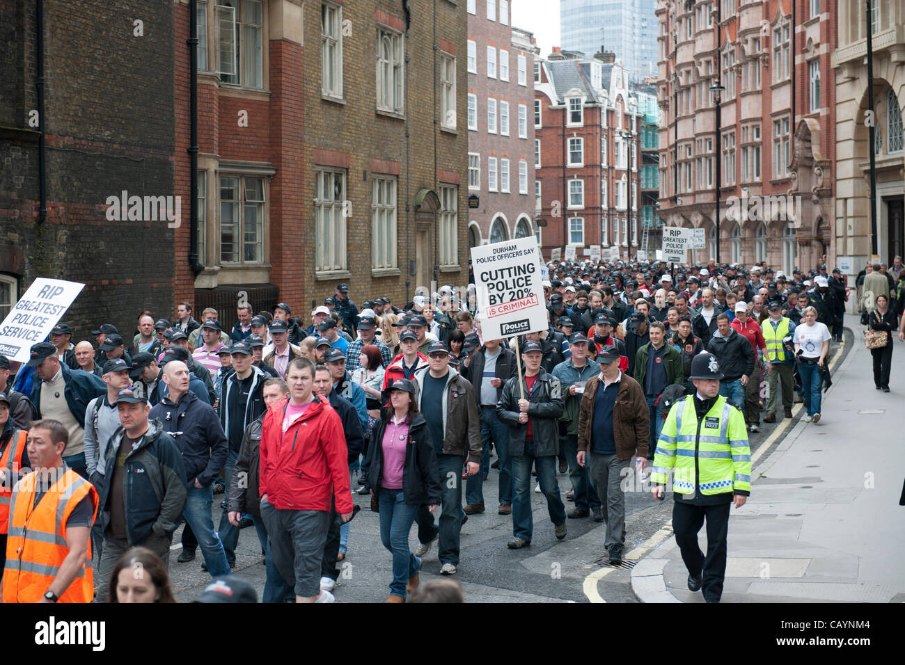 UK police officers and supporters march through central London to ...