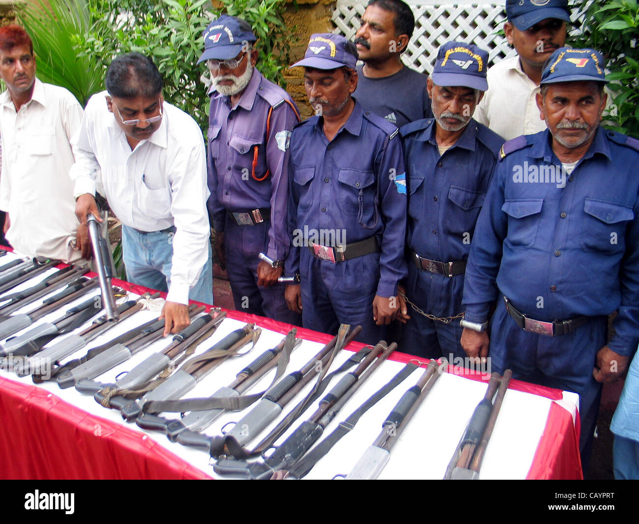 Policemen show handcuffed accused, who were allegedly involved in bank ...