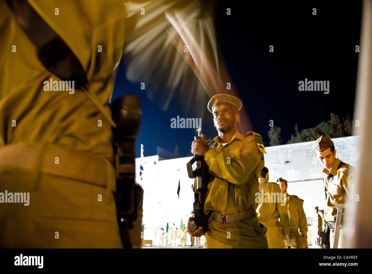 A soldier holds an IMI TAR-21 Tavor assault rifle saluting his platoon ...