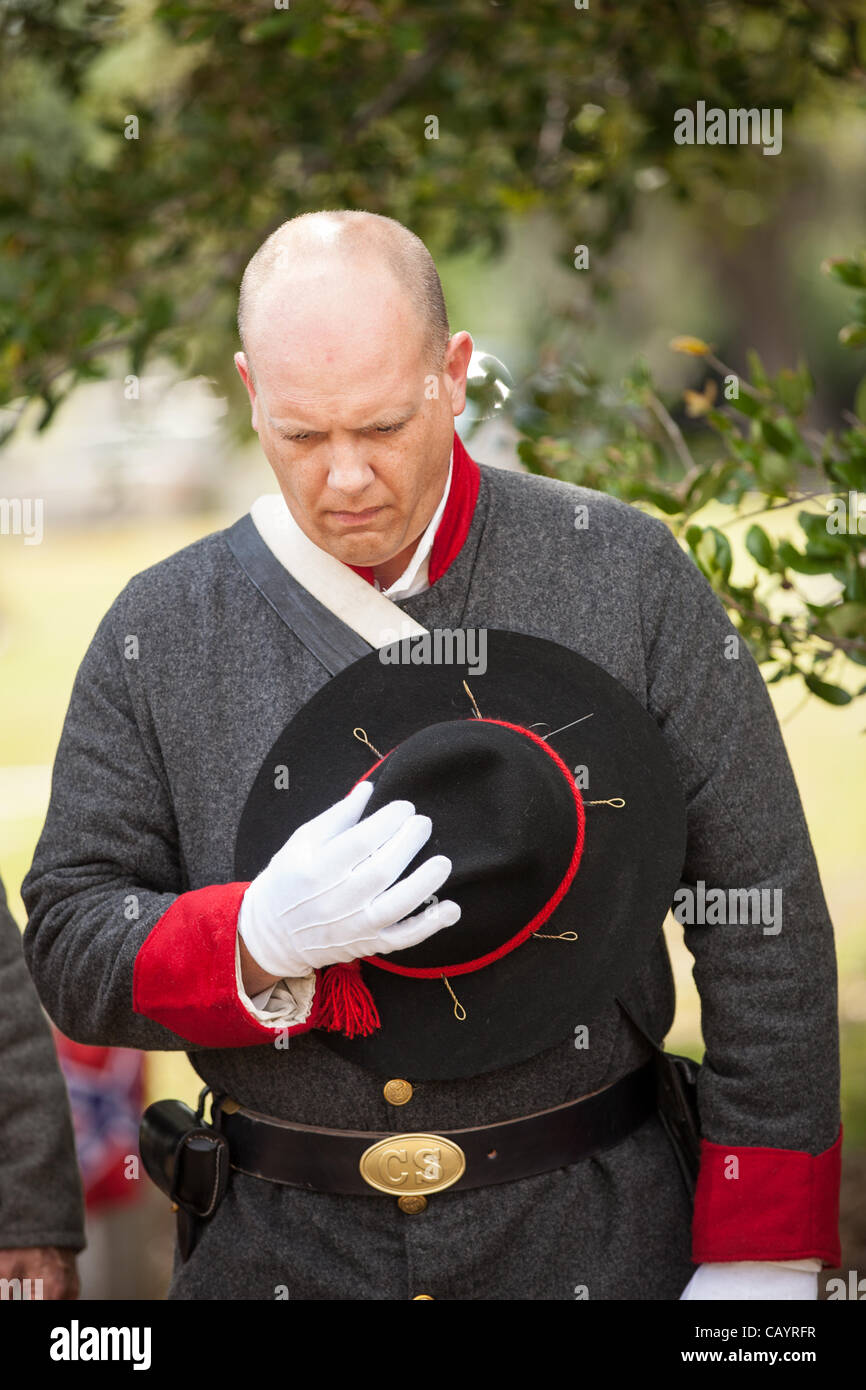 A historic re-enactor stands during a prayer during a ceremony in honor ...