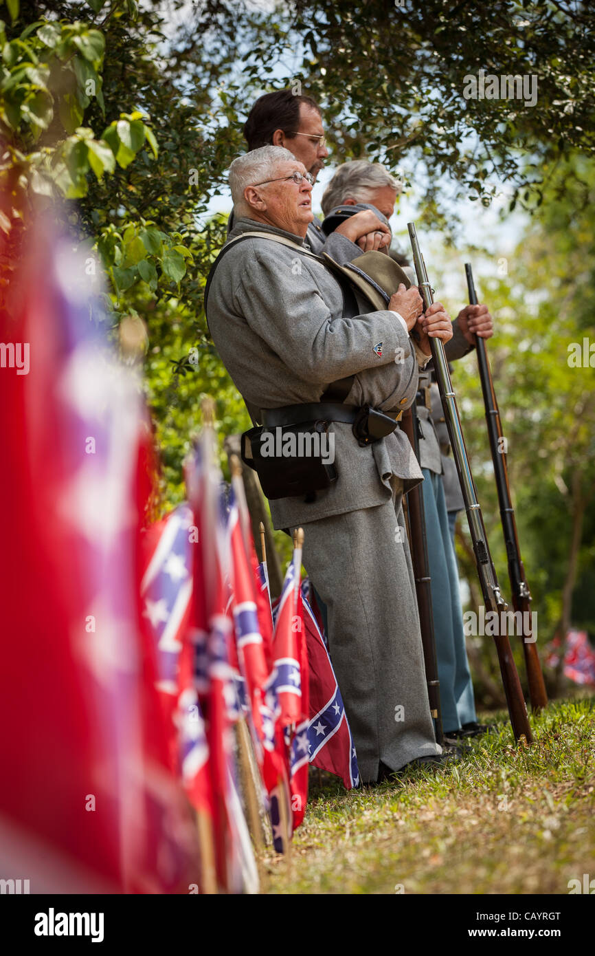 A historic re-enactors stands for a prayer during a ceremony in honor ...