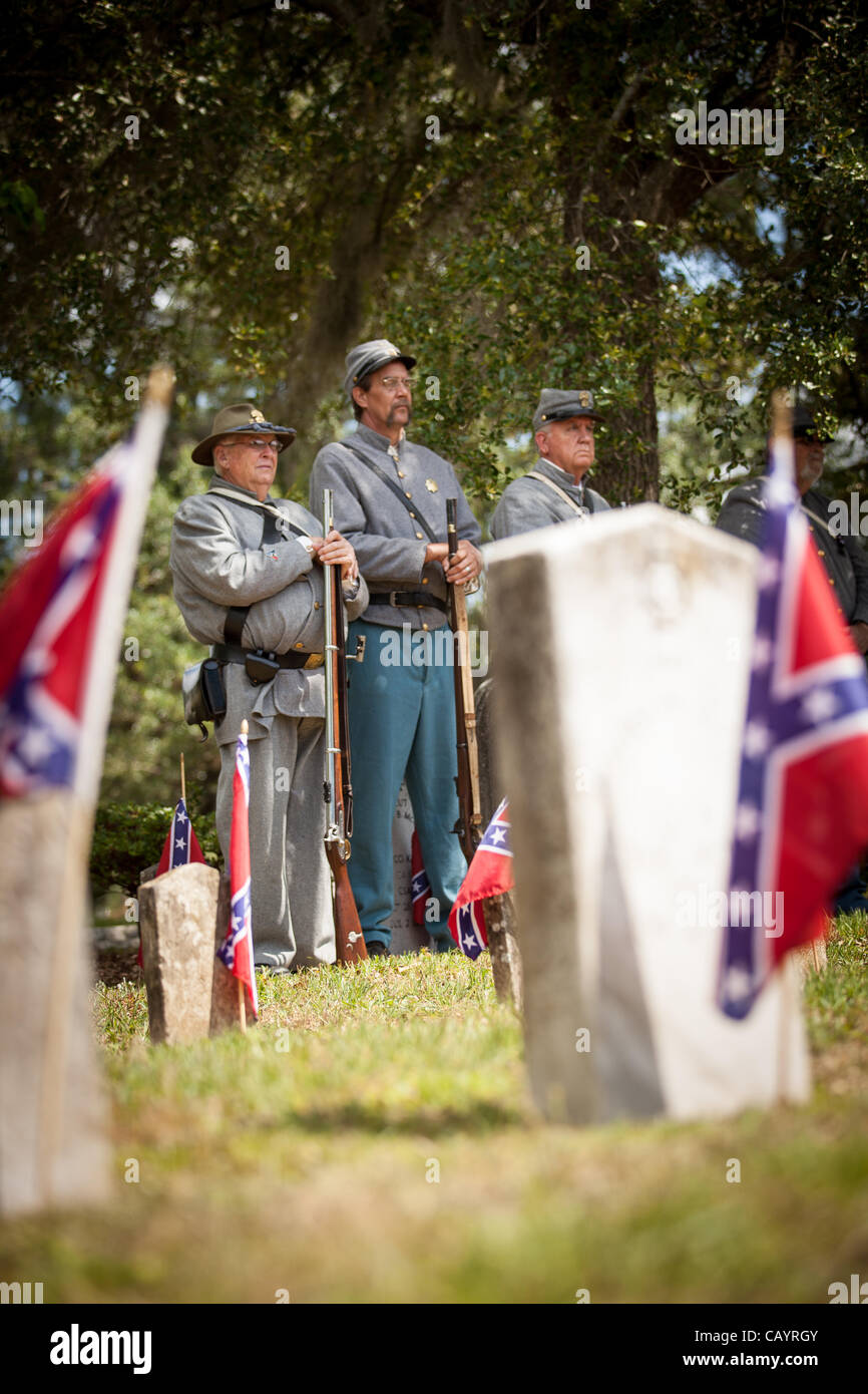 A historic re-enactors stands for a prayer during a ceremony in honor ...