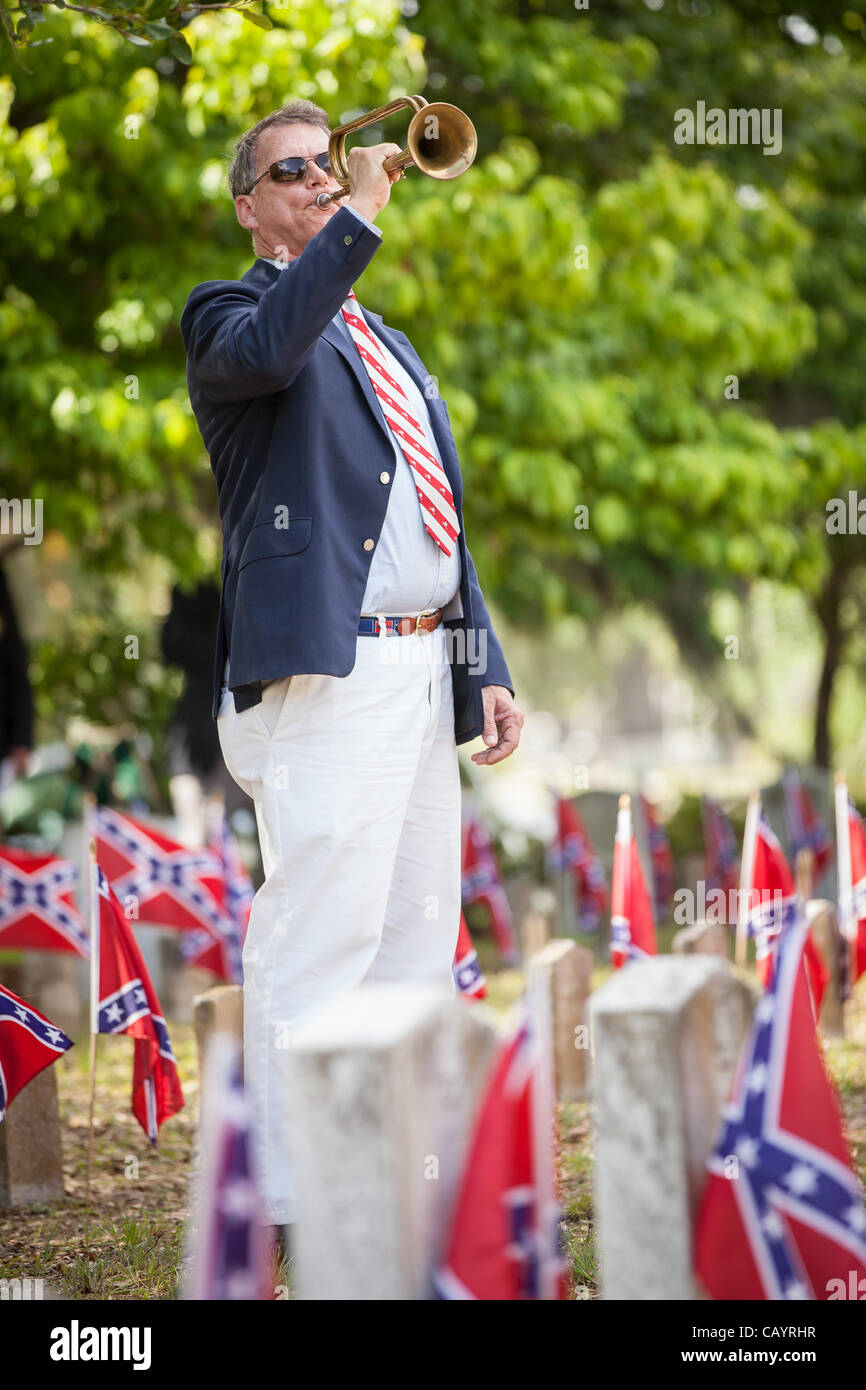 A historic re-enactors plays taps on a bugle during a ceremony in honor ...