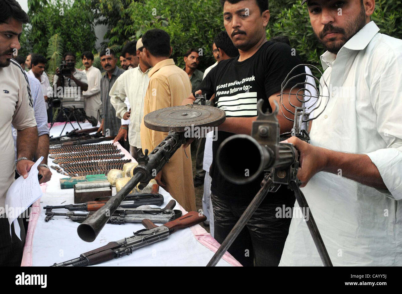 CID police officials inspect seized weapons and bullets, which were ...