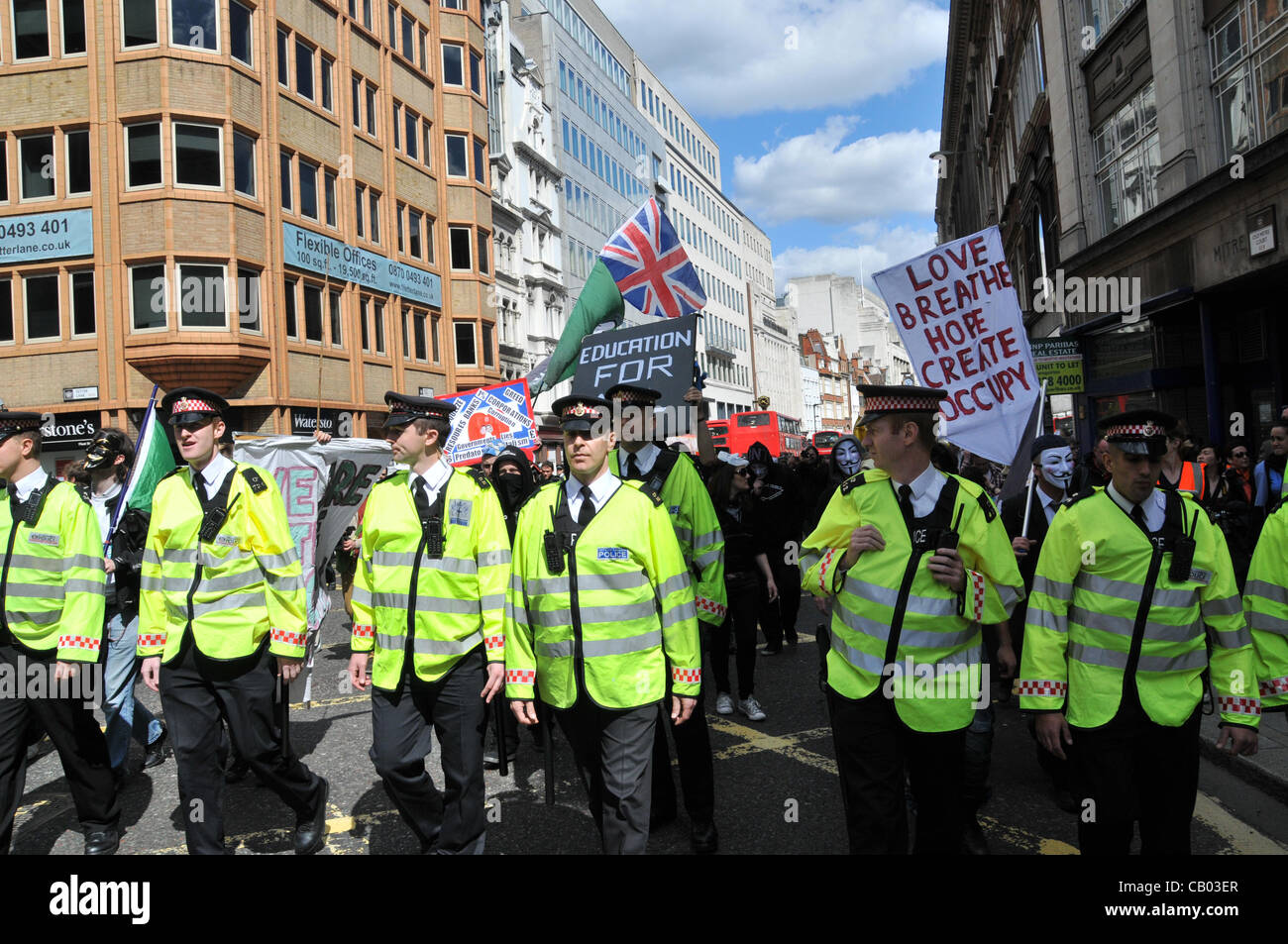 Occupy London demonstrators and police officers march as the Occupy ...