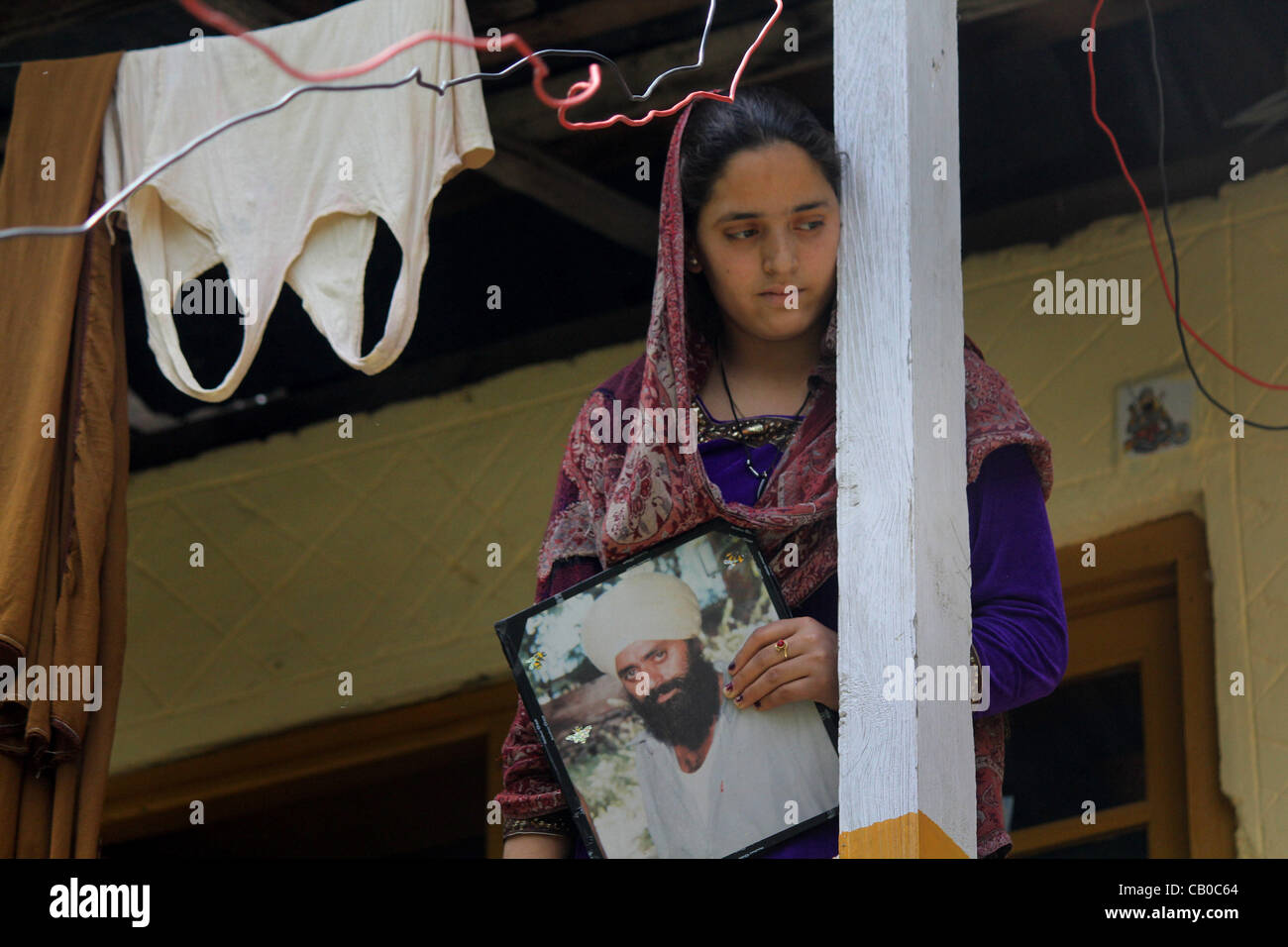 Gurpat core 21 years old Kashmiri Sikh girl hold photograph of her ...