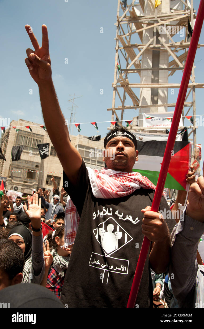 RAMALLAH, PALESTINIAN TERRITORIES - MAY 15, 2012: A Palestinian flashes ...