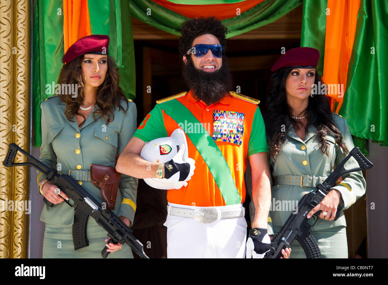 Actor Sacha Baron Cohen dressed in character as 'The Dictator' flanked ...