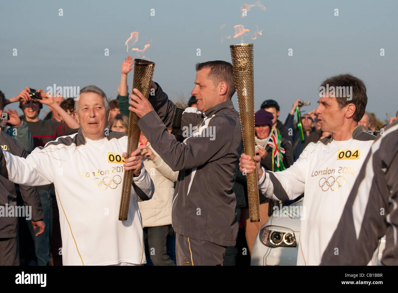 Falmouth, UK. 19 May, 2012. Eric Smith hands the Olympic torch to Steve ...