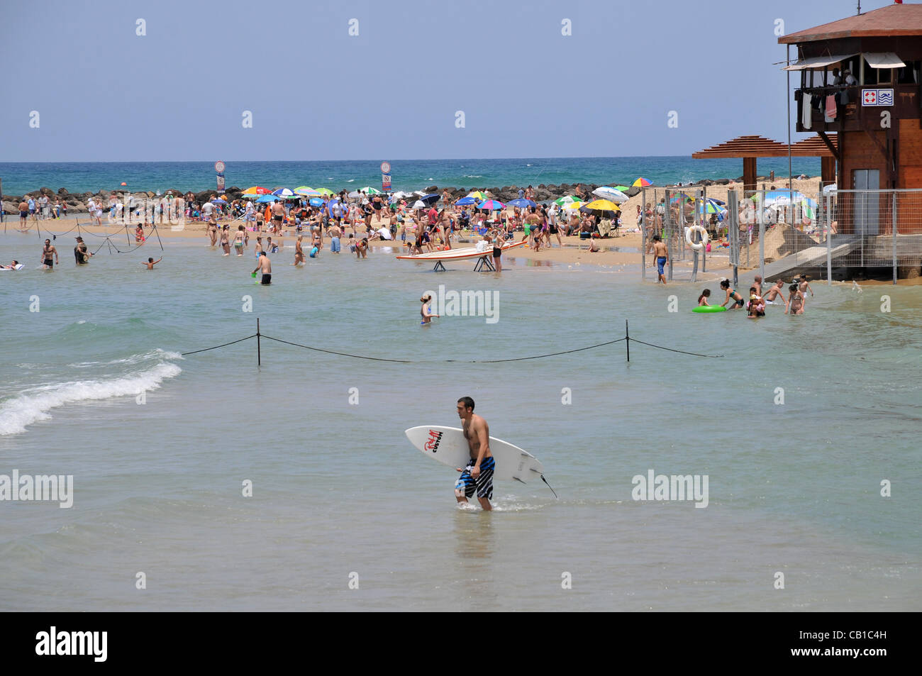 Israelis vacationing at the beach in Haifa, spending a summer day. May ...