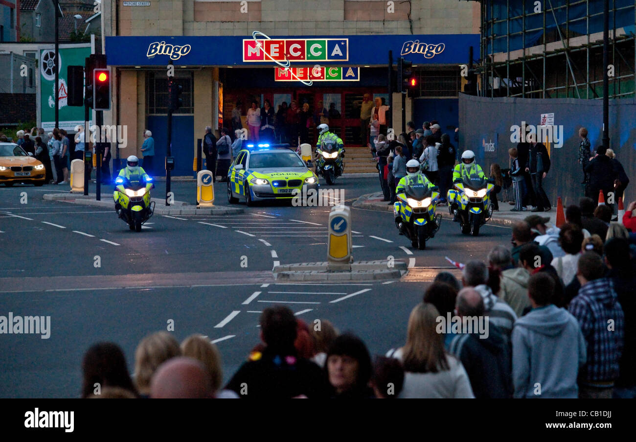 A motorcade of police motorbikes and cars precede the Olympic Torch ...