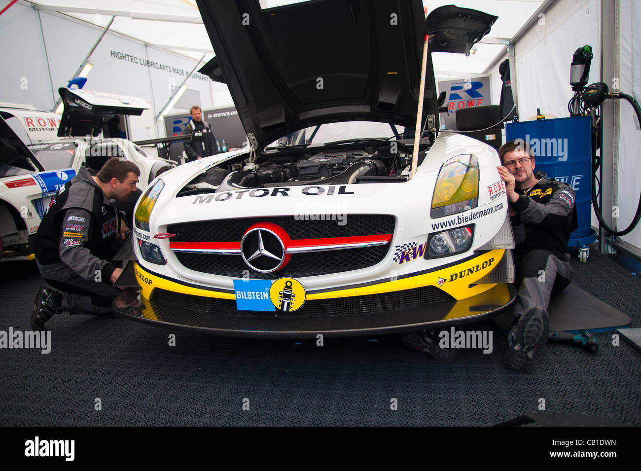 Crew work on an Mercedes-Benz SLS AMG GT3 during pre-race activities ...