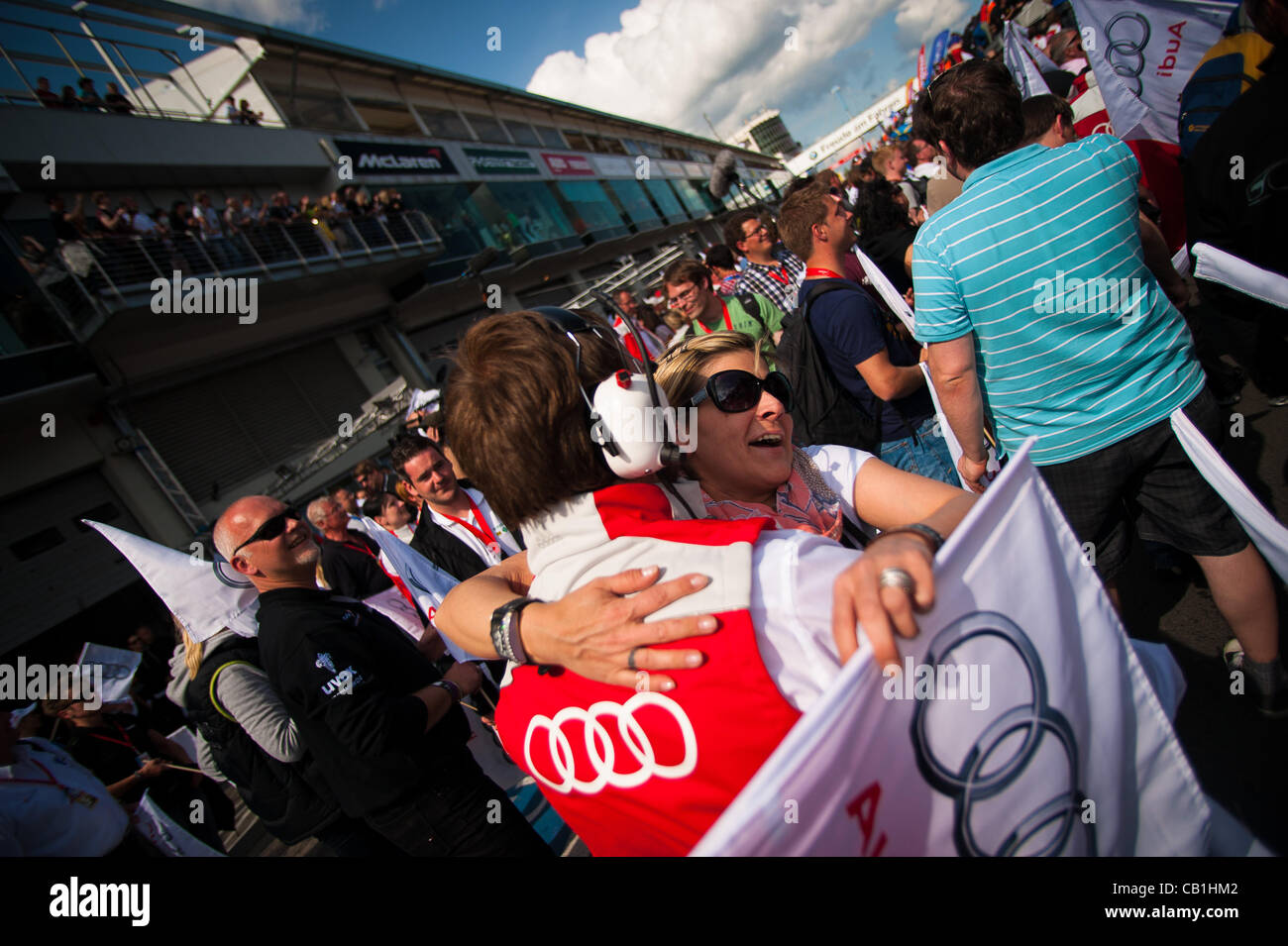 Audi Sport Team Phoenix pit crew and fans crowd the paddock area to ...