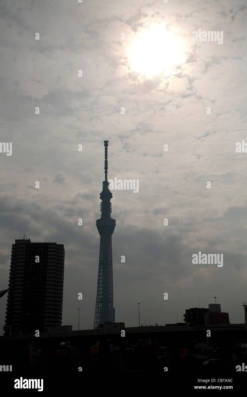 Skies darken behind Tokyo Sky Tree as the moon passes in front of the ...