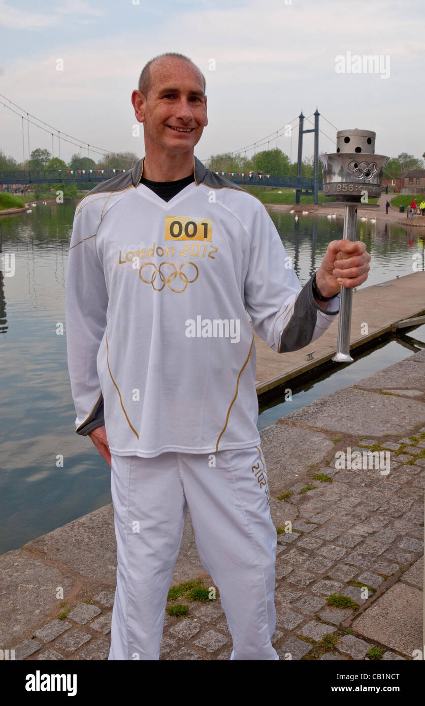 Olympic Torchbearer Paul Giblin, from Exeter Respect festival, holds ...