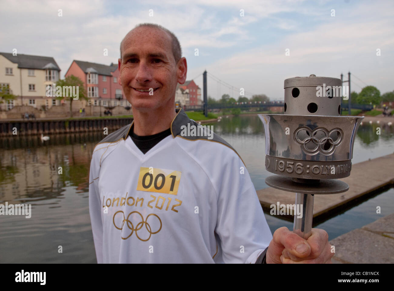 Olympic Torchbearer Paul Giblin, from Exeter Respect festival, holds ...