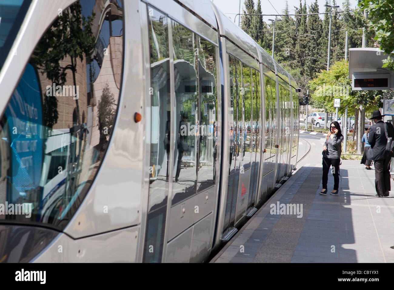 Passengers board Jerusalem Light Rail Transit tram at Herzl Boulevard ...